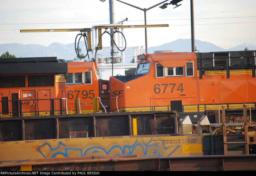 BNSF 6774 and BNSF 6795 on Different Tracks wait to roll out of the BNSF Commerce City Fuel Pits.